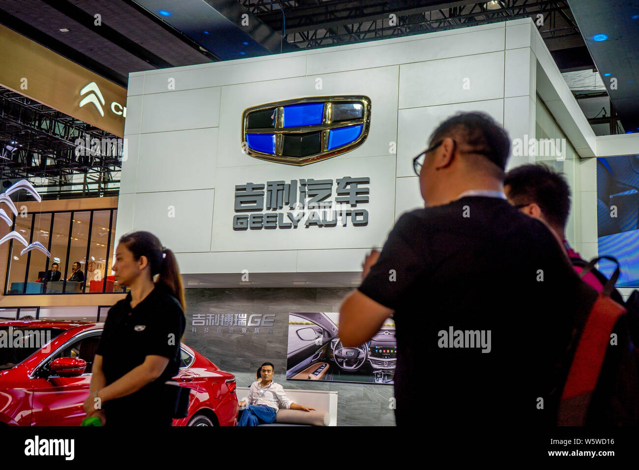 --FILE--People visit the stand of Geely during the 16th China ...