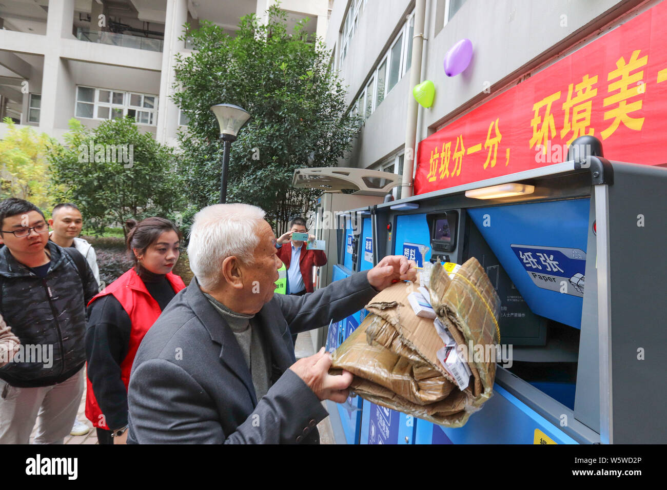 --FILE--Residents sort their garbage and recyclables into the ...