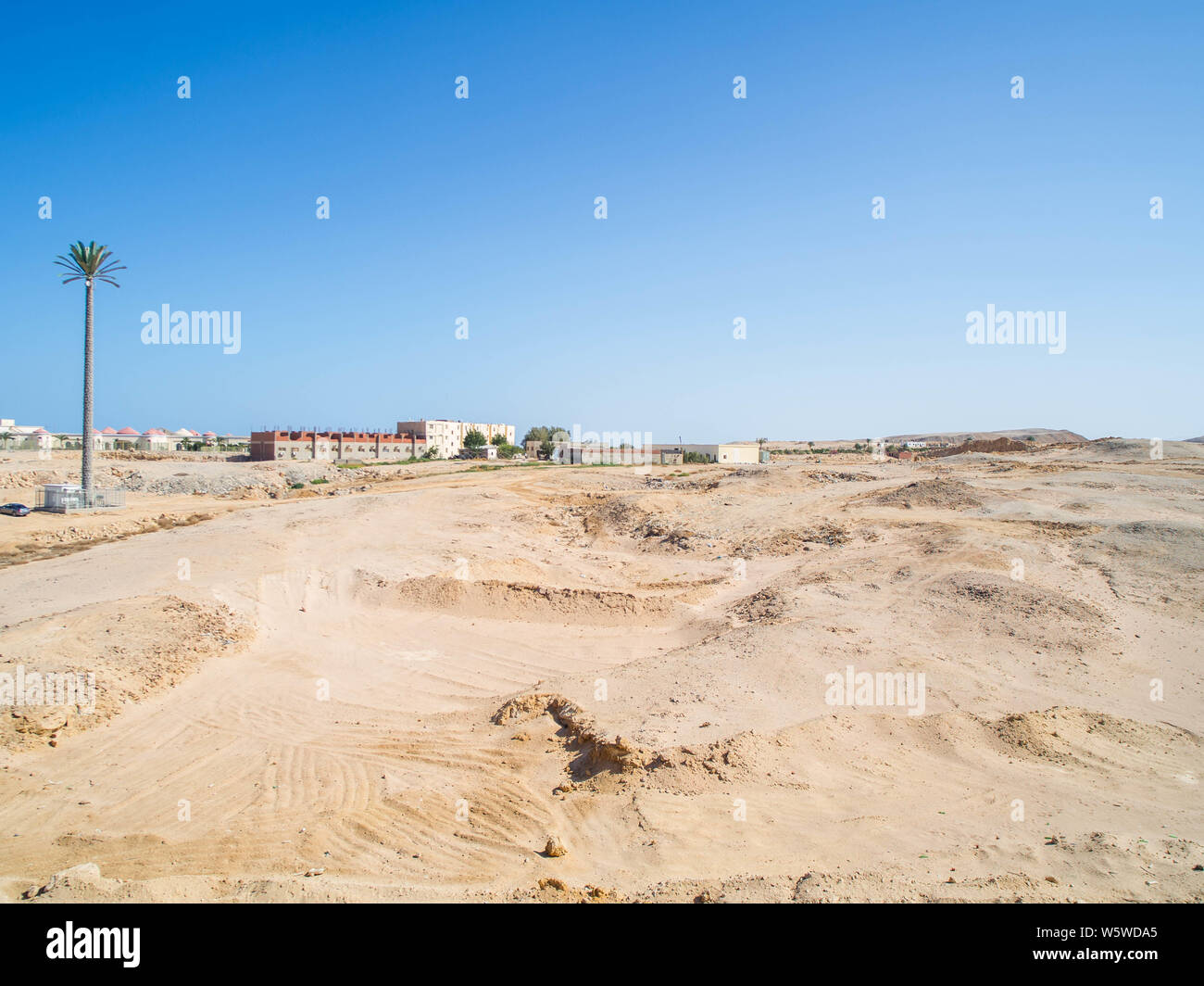 Road in the desert Side View , palm and houses in distance Stock Photo ...
