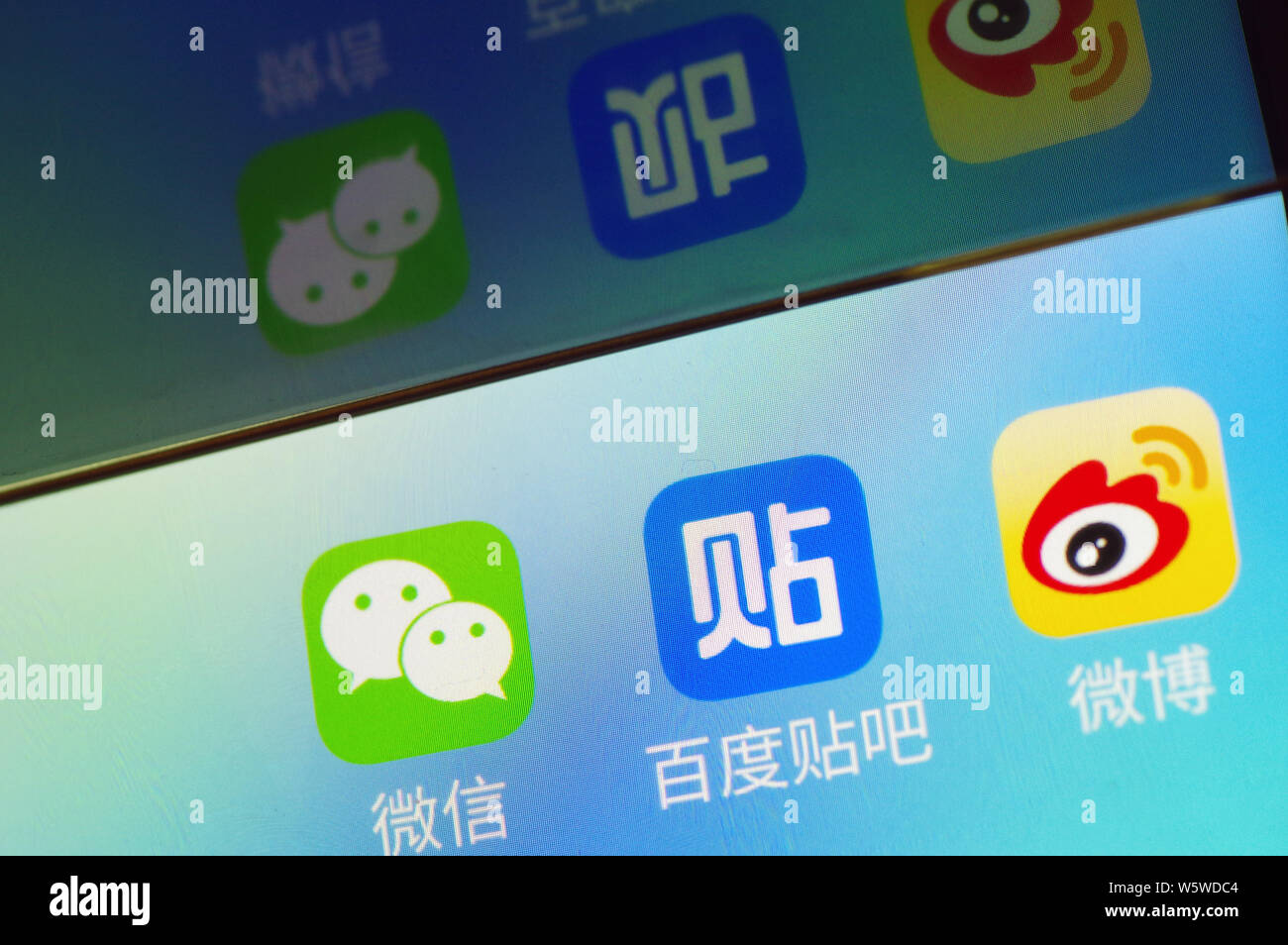 --FILE--A Chinese mobile phone user shows the icons of (from left ...