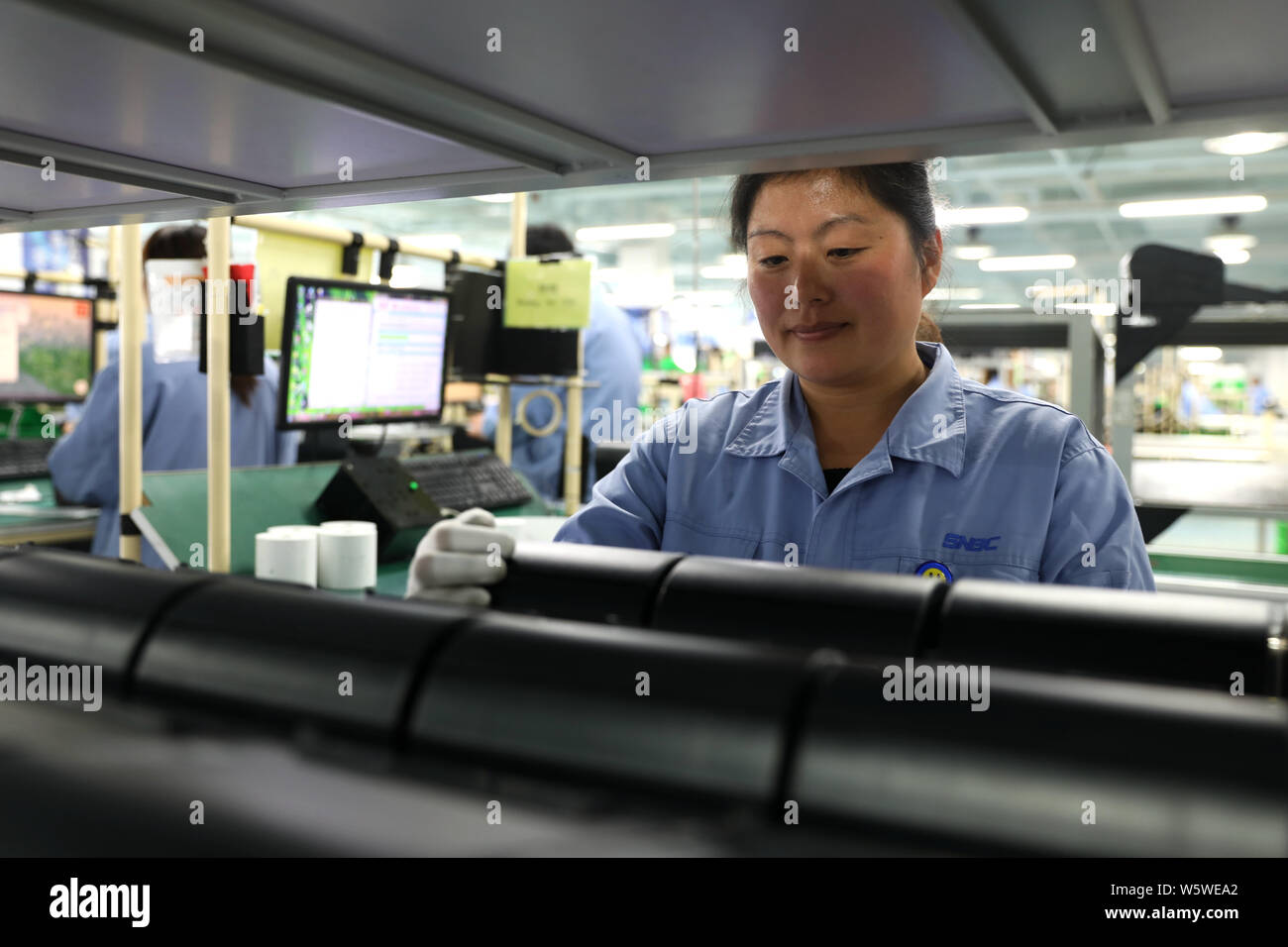 --FILE--A Chinese worker assembles printers at a factory in Weihai ...