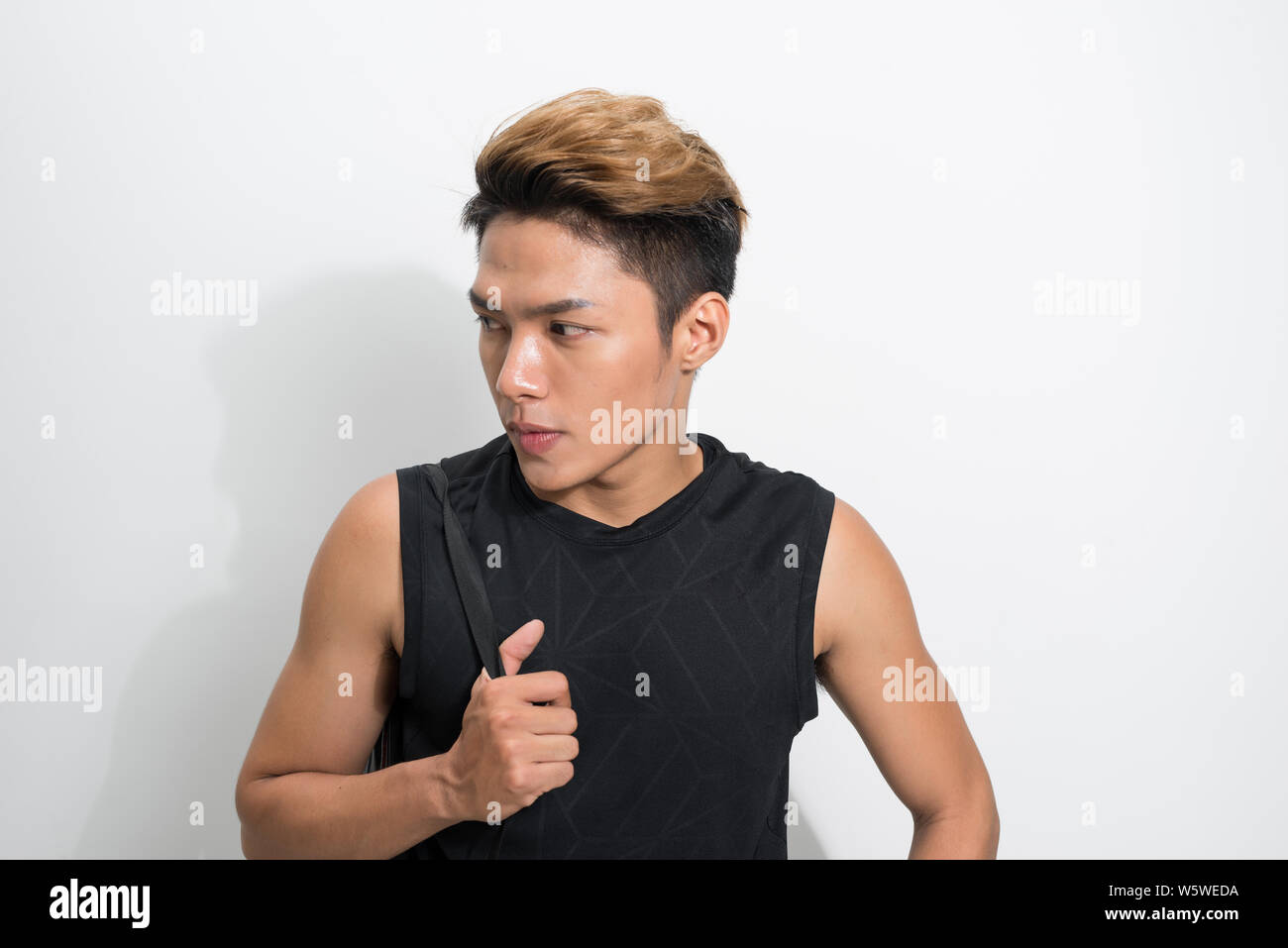 Portrait of Young man badminton player over white studio background ...