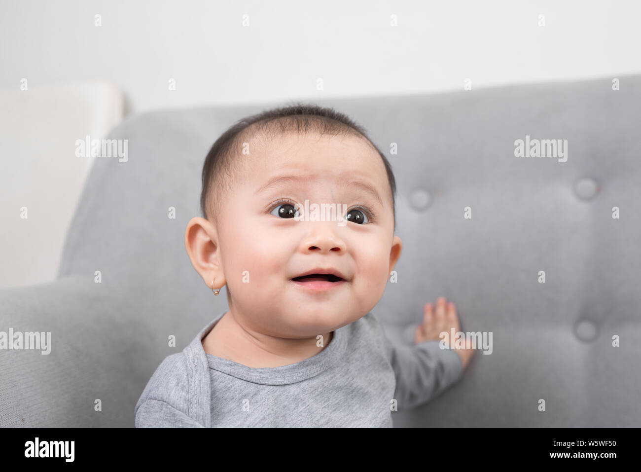 childhood, babyhood and people concept - happy little baby girl sitting ...