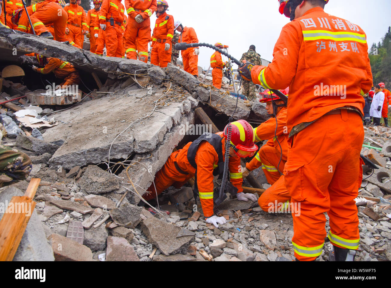 Chinese rescuers search for survivors at the accident site after a ...