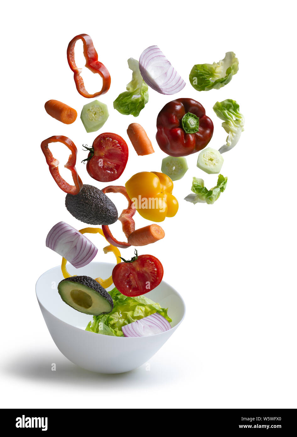 Fresh salad vegetables flying isolated from the background Stock Photo ...