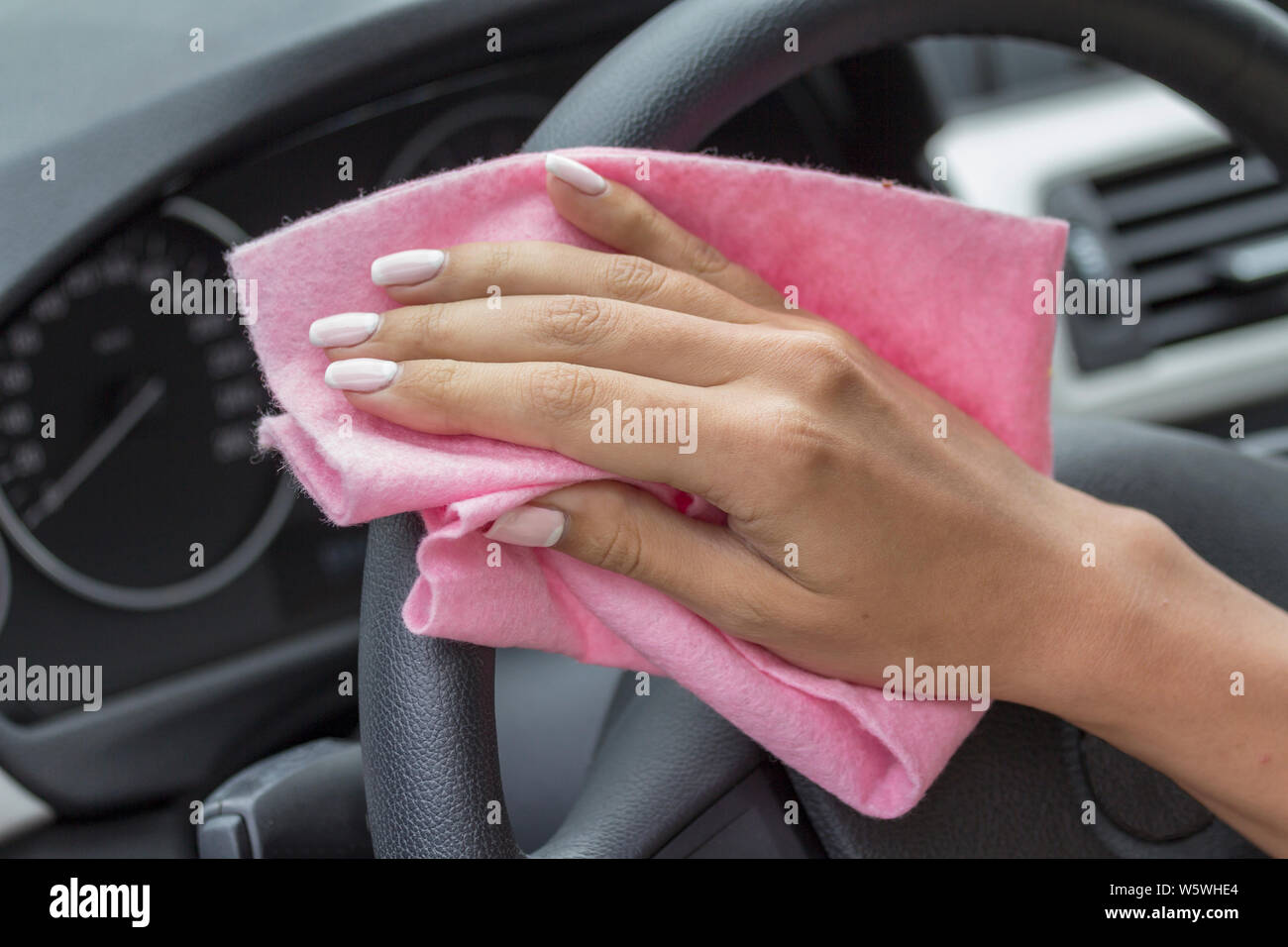 Girls pink cloth wipe the hand wheel in the car Stock Photo - Alamy
