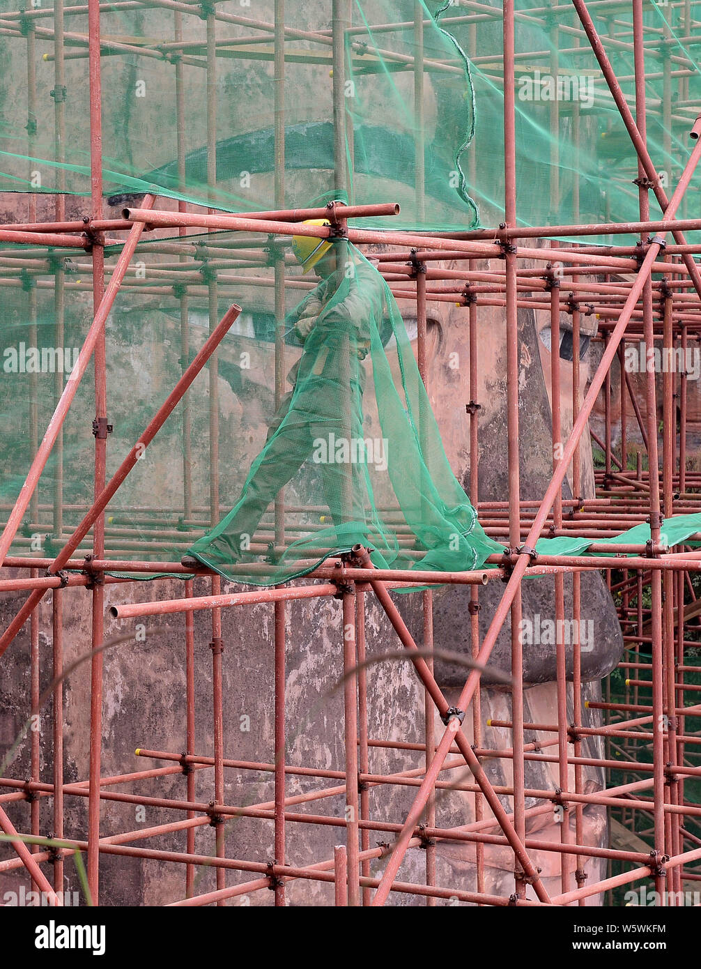 The Leshan Giant Buddha is covered with scaffolding for a restoration ...