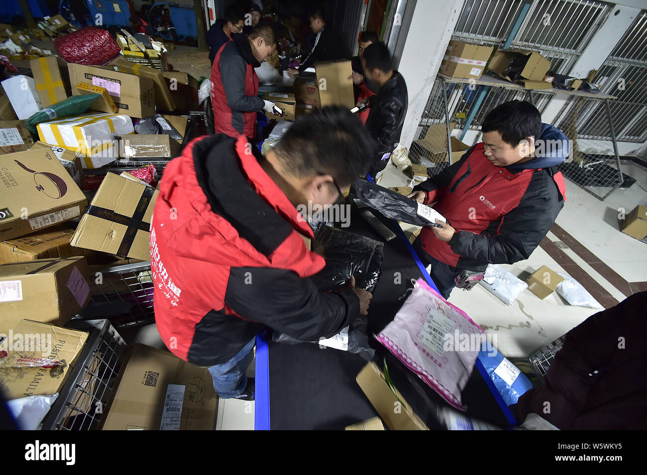 Chinese workers sort out parcels, most of which are from Singles' Day ...