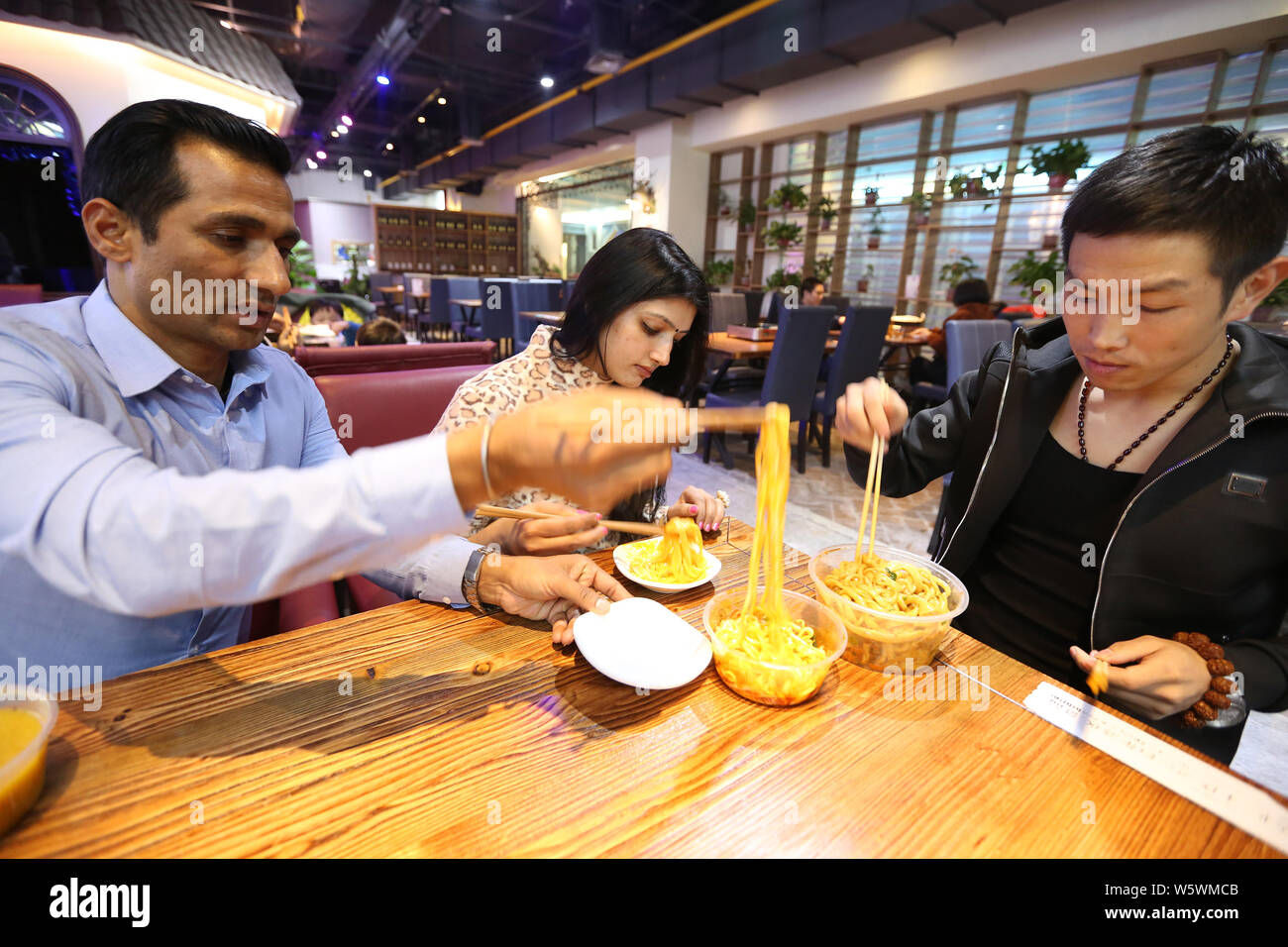 Indian man Dev Raturi, who owns eight restaurants, and his families eat ...