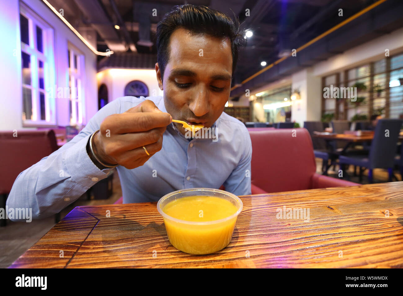 Indian man Dev Raturi, who owns eight restaurants, and his families eat ...