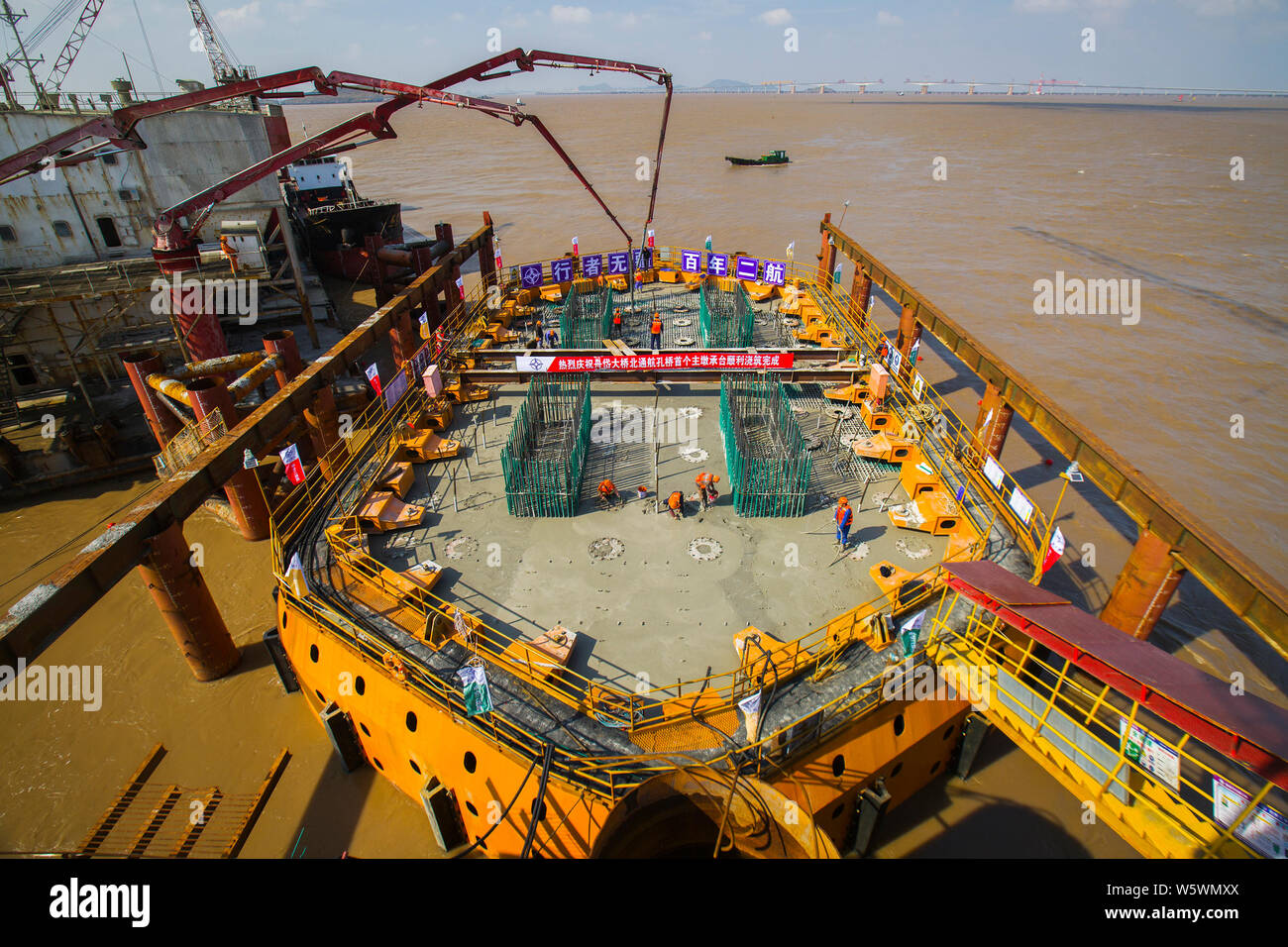 Chinese workers pour concrete on the main pier pile cap of the Ningbo ...