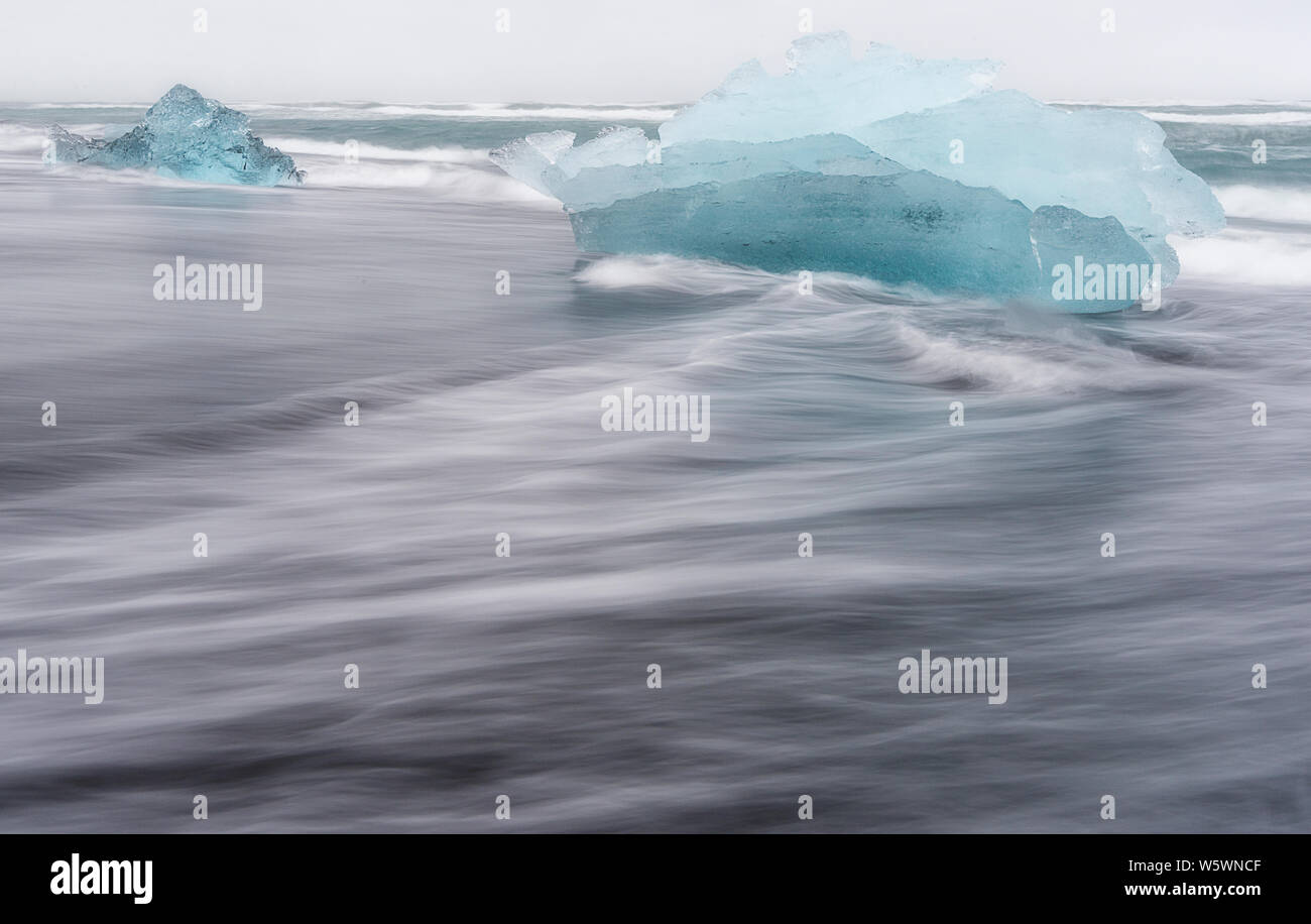 Melted glacier ice blocks floating as diamond crystals in Jokulsarlon ...