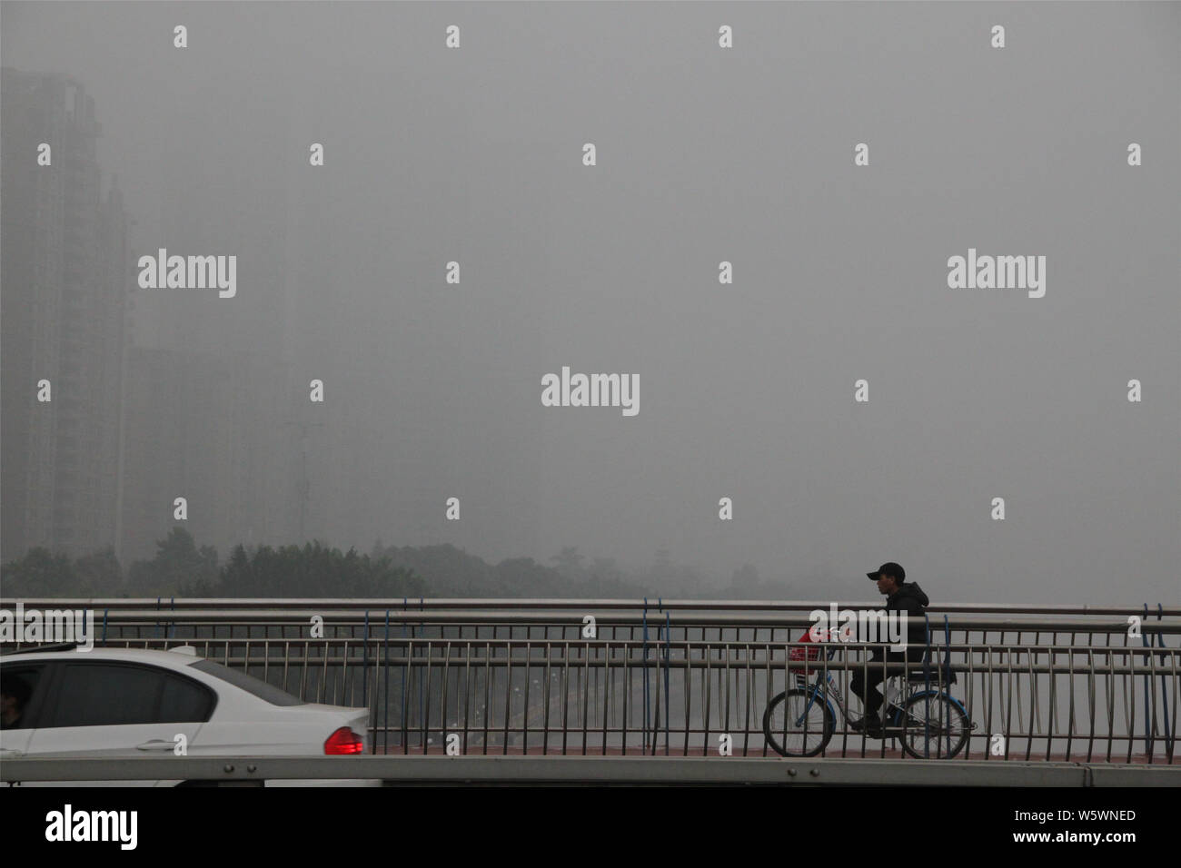 --FILE--A cyclist wearing a face mask against air pollution rides in ...