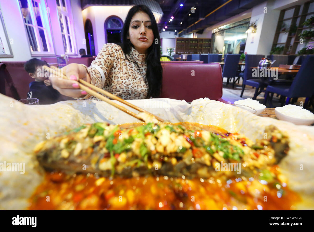 Indian man Dev Raturi, who owns eight restaurants, and his families eat ...