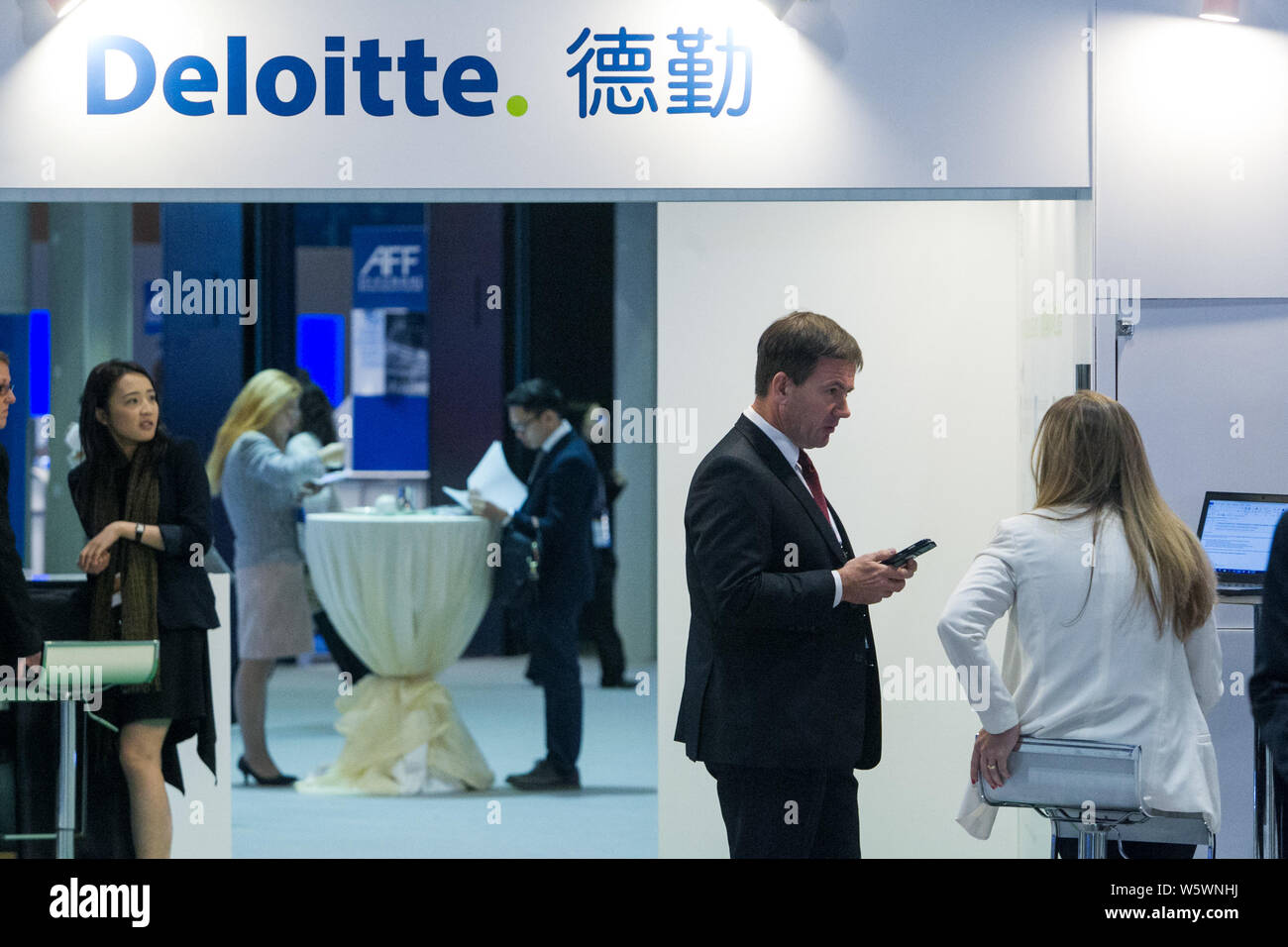 --FILE--People visit the stand of Deloitte during an exhibition in Hong Kong, China, 19 January ...
