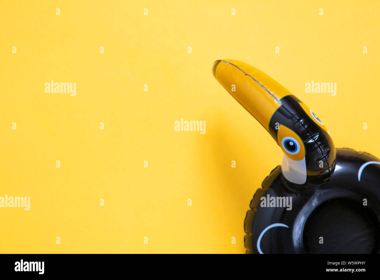 Pelican summer inflatable holiday pool toy against a bright yellow ...