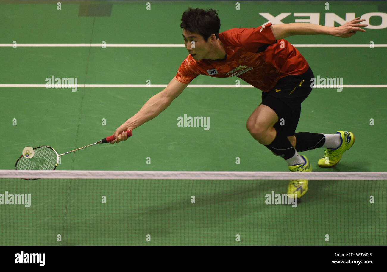 Son Wan-ho of South Korea returns a shot to Kento Momota of Japan in ...