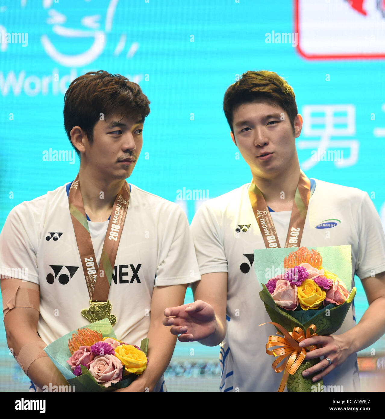 Kim Gi-jung and Lee Yong-dae of South Korea pose with their trophies ...