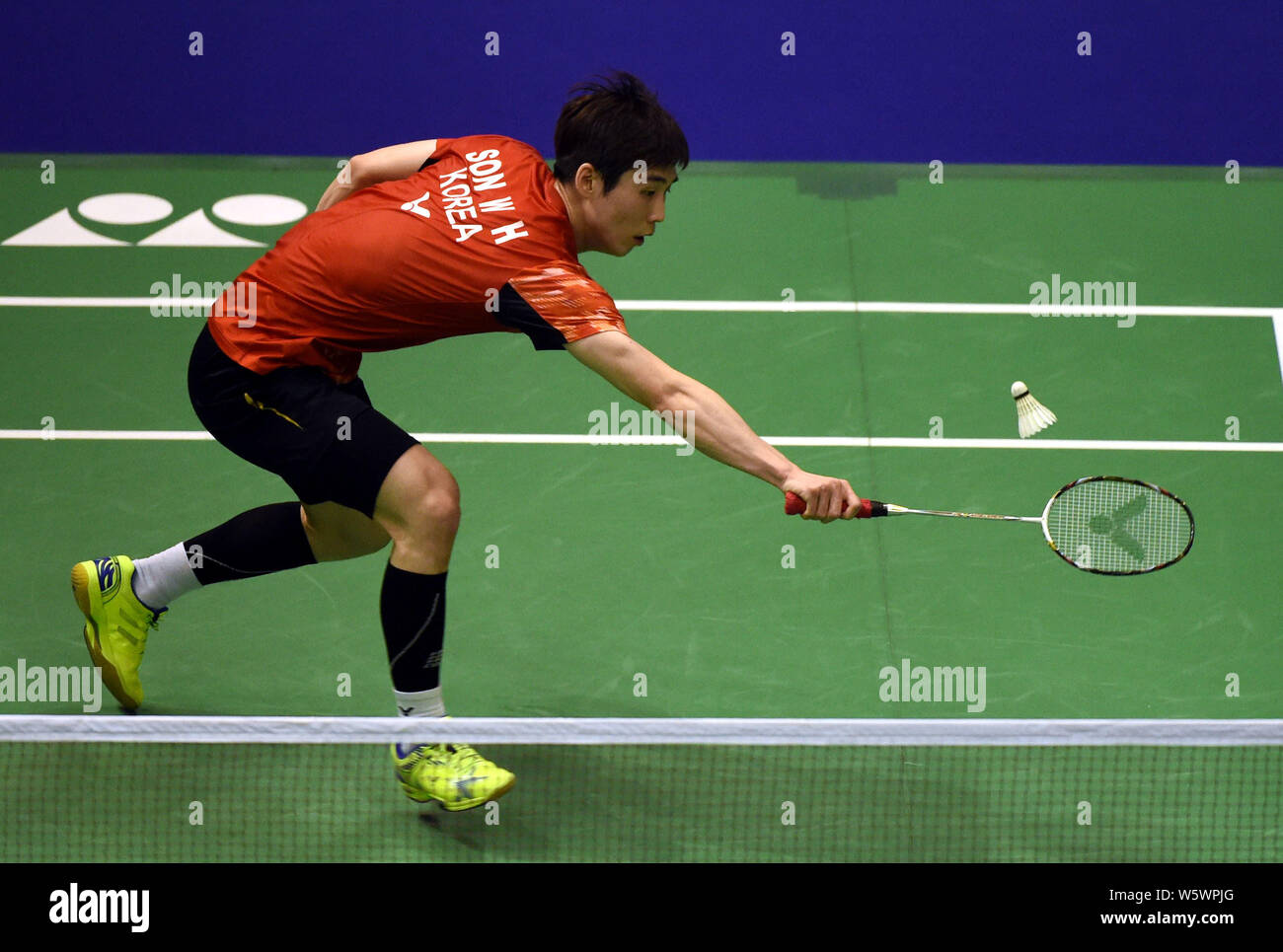 Son Wan-ho of South Korea returns a shot to Kento Momota of Japan in ...