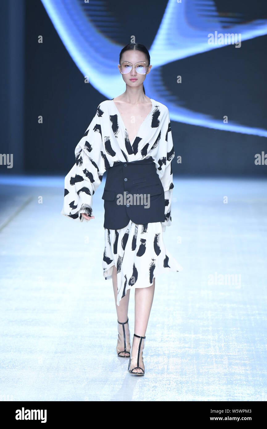 A model displays a new creation at the fashion show of Oriental Modern ...