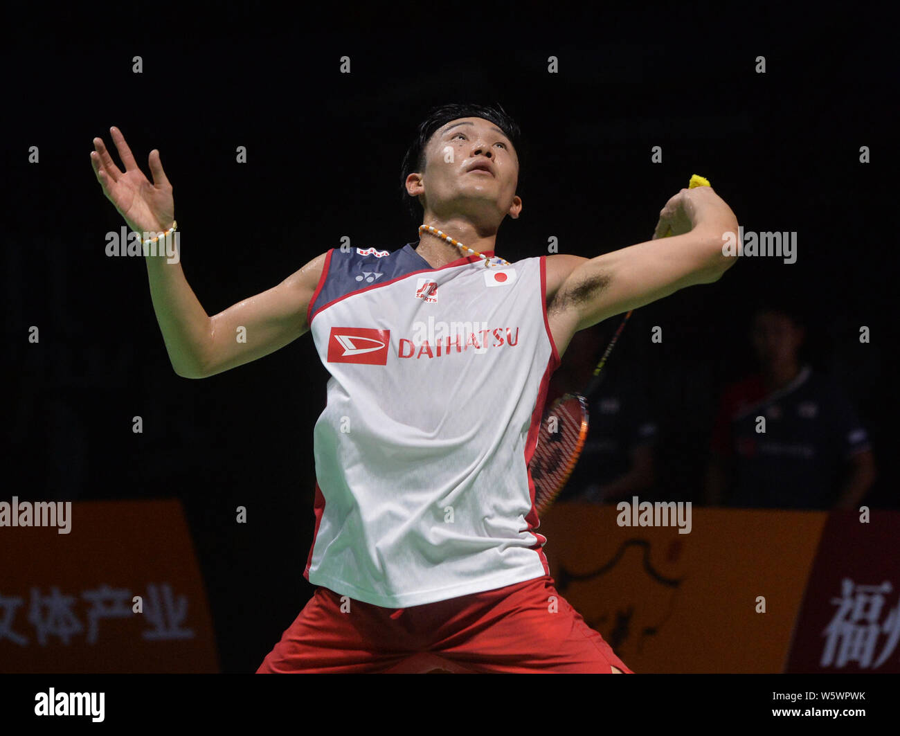Kento Momota of Japan plays a shot to Chou Tien Chen of Chinese Taipei ...