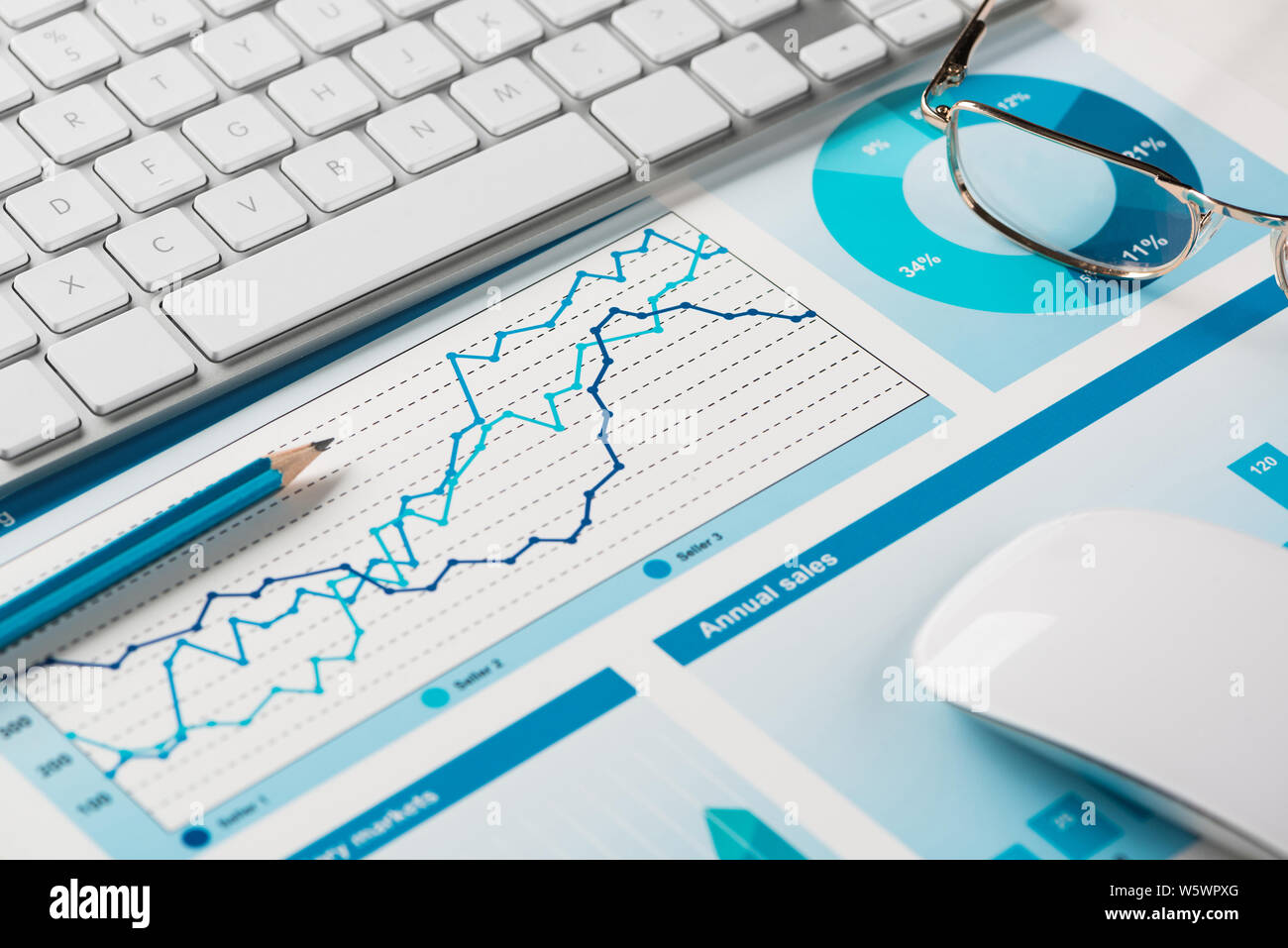 Business workplace with keyboard mouse and papers with graphs and ...