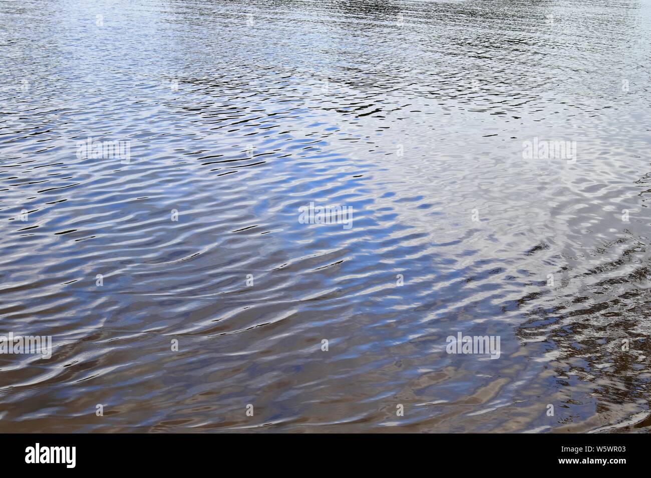 Beautiful close up water surfaces with waves and ripples reflecting the ...