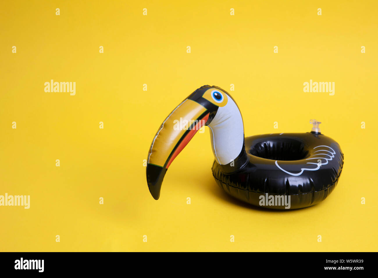 Pelican summer inflatable holiday pool toy against a bright yellow ...