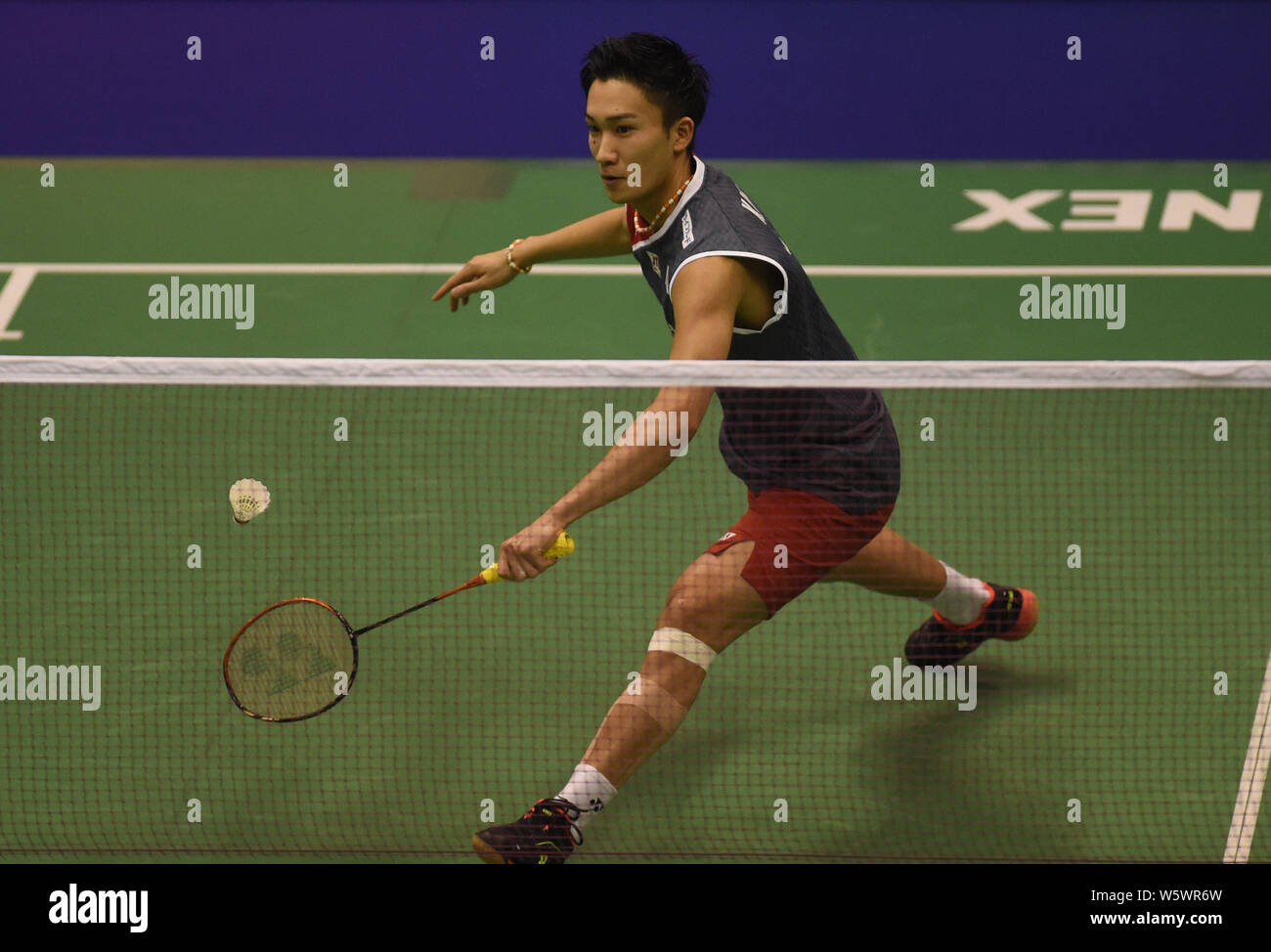 Kento Momota of Japan returns a shot to Jonatan Christie of Indonesia ...