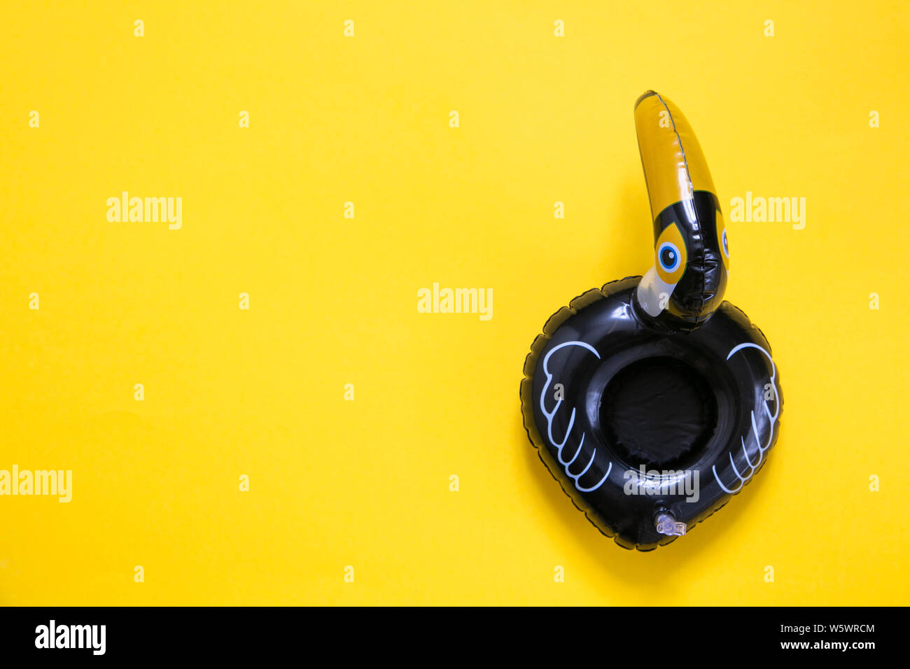 Pelican summer inflatable holiday pool toy against a bright yellow ...