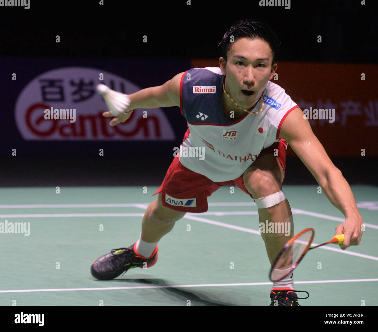 Kento Momota of Japan plays a shot to Chou Tien Chen of Chinese Taipei ...
