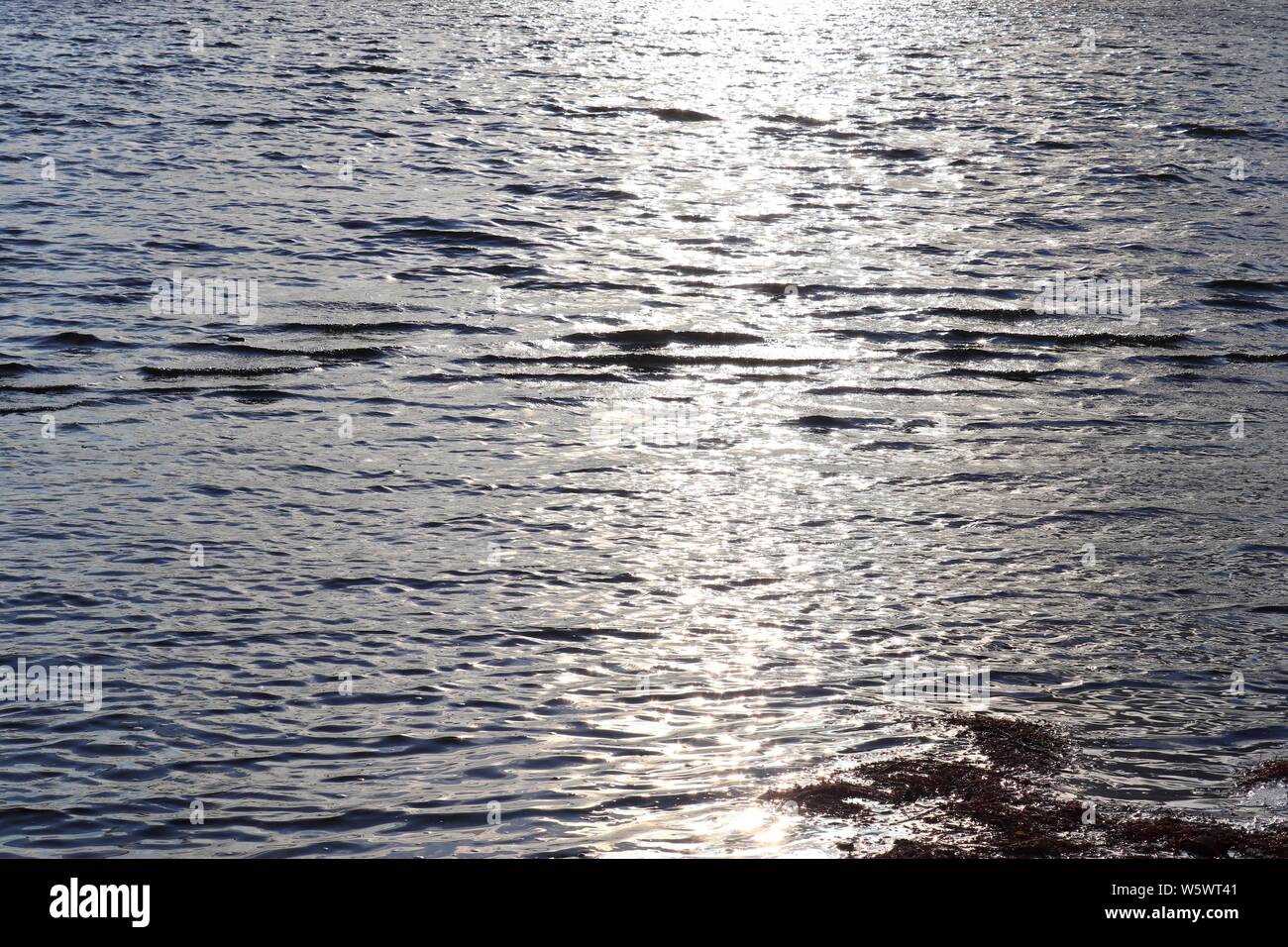 Beautiful close up water surfaces with waves and ripples reflecting the ...