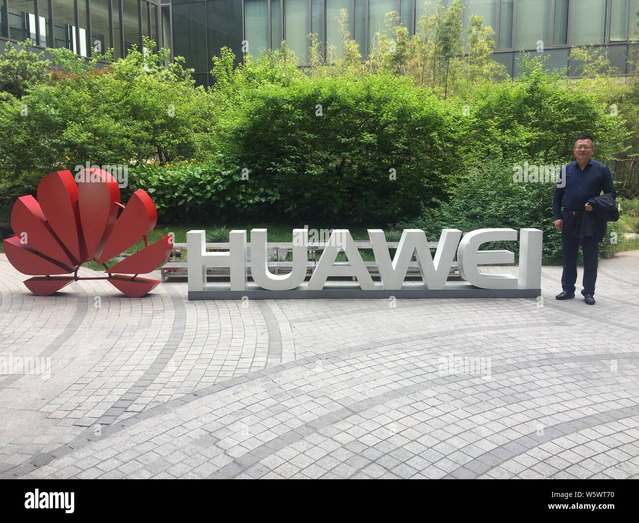--FILE--A man is pictured at an office building of Huawei in Hangzhou ...