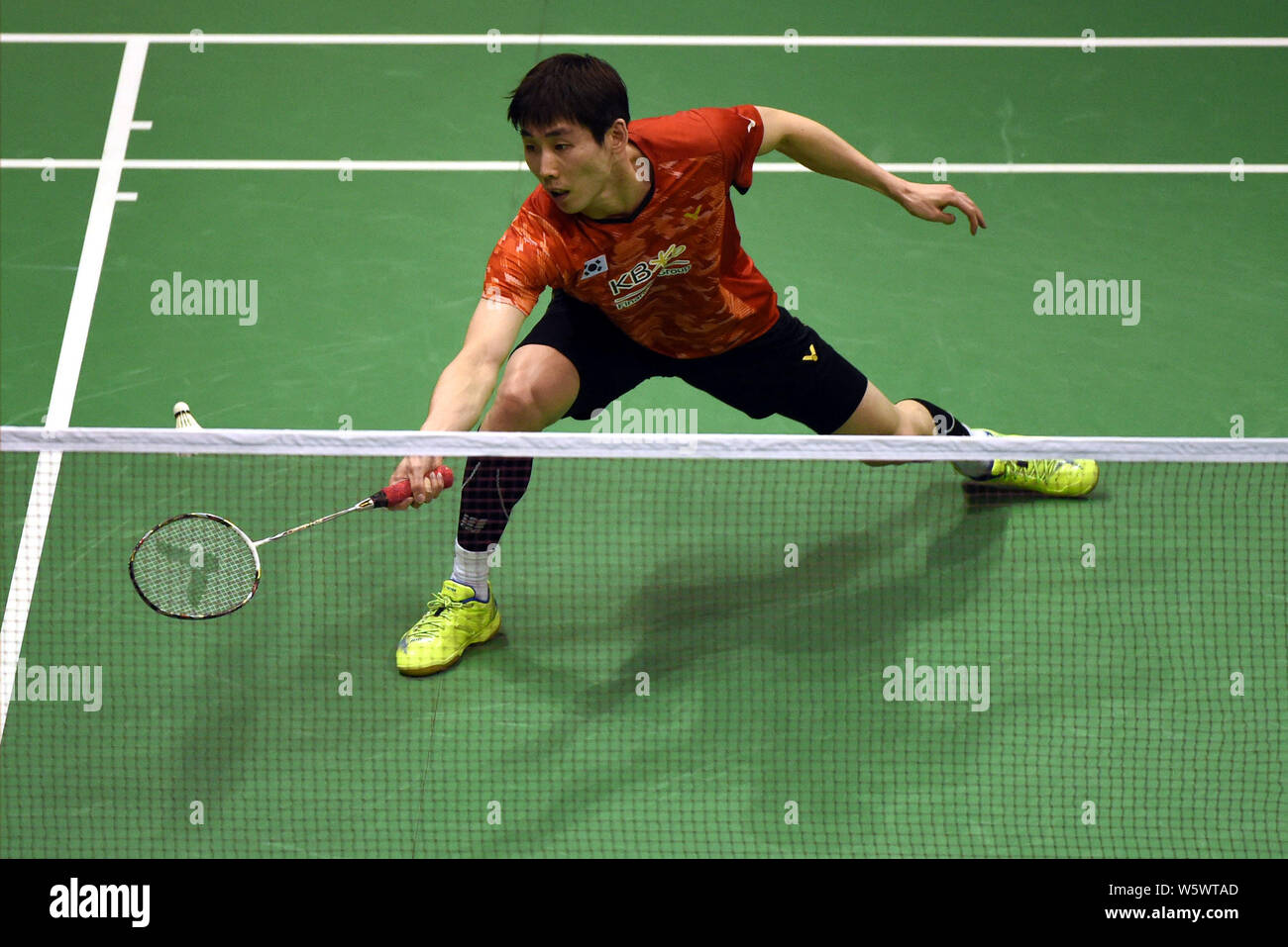 Son Wan-ho of South Korea returns a shot to Kento Momota of Japan in ...