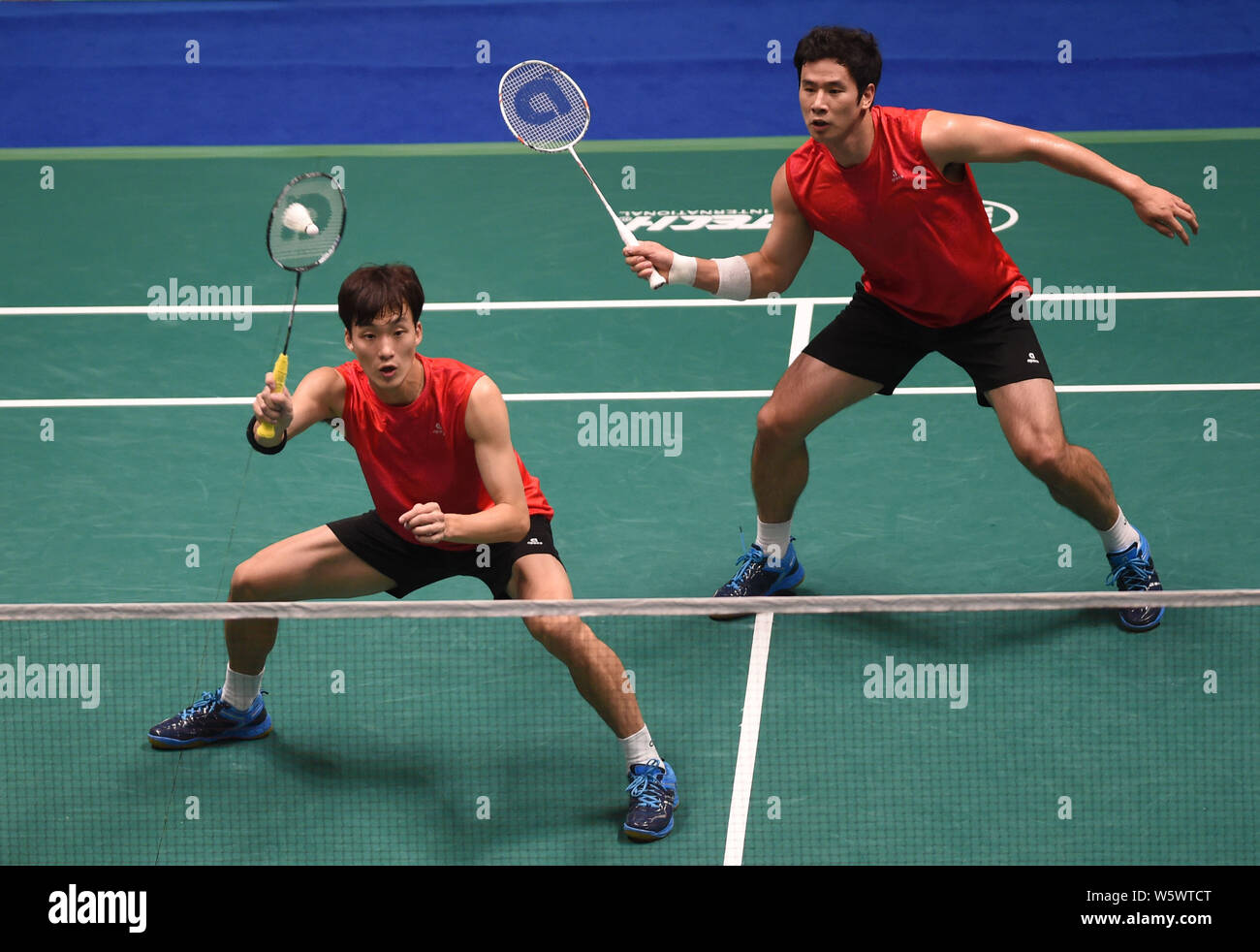 Ko Sung-hyun and Shin Baek-cheol of South Korea compete against Kim Gi ...
