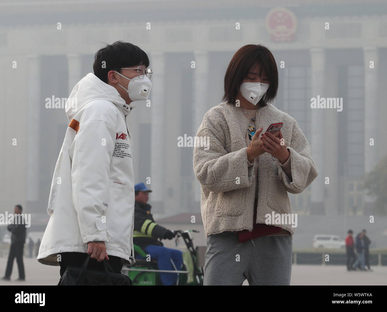 Chinese tourists wearing face masks against air pollution visit the ...