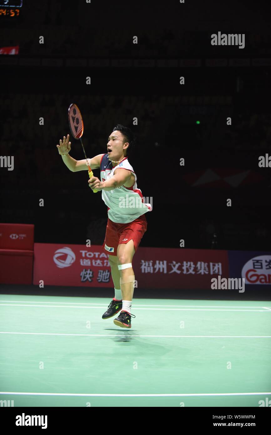 Kento Momota of Japan plays a shot to Chou Tien Chen of Chinese Taipei ...