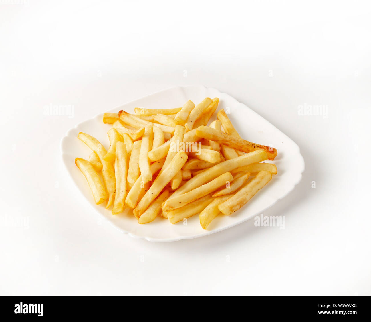 Serving French fries on a plate, side view, on a white background ...