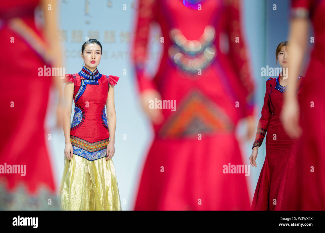 A model displays a new creation of traditional Mongolian costumes ...