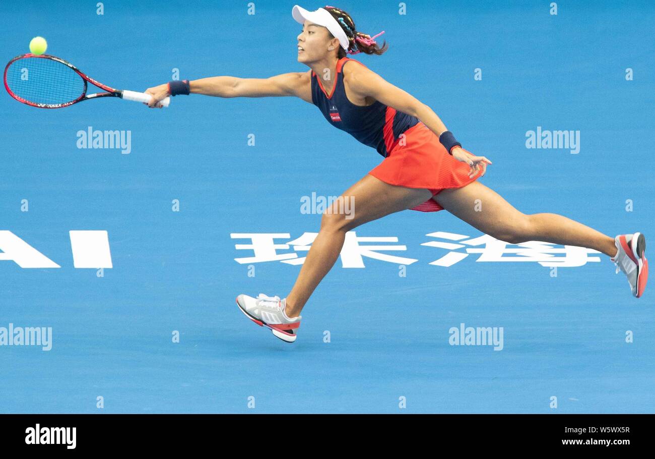 Wang Qiang of China returns a shot to Ashleigh Barty of Australia in ...