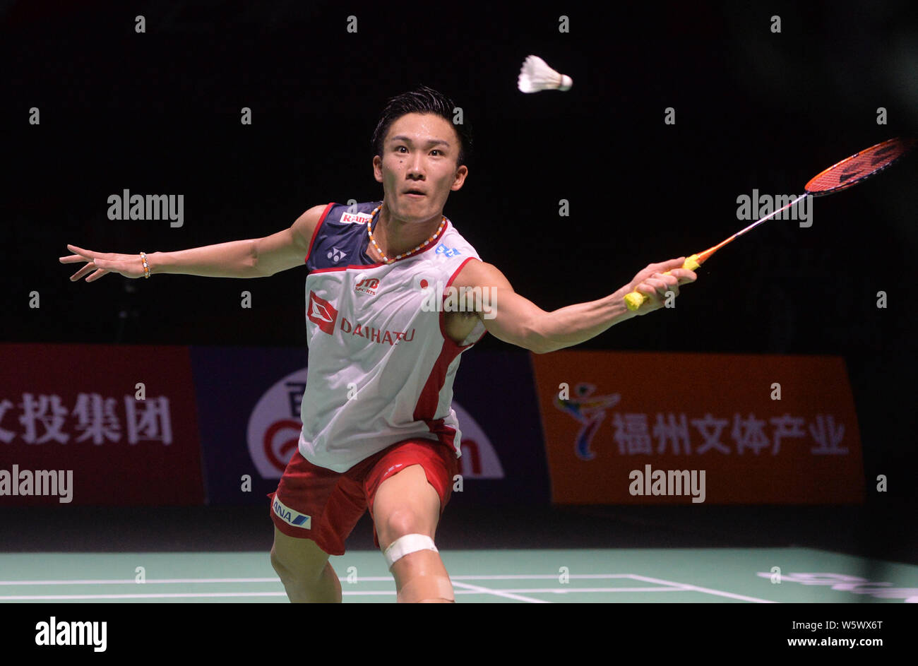 Kento Momota of Japan plays a shot to Chou Tien Chen of Chinese Taipei ...