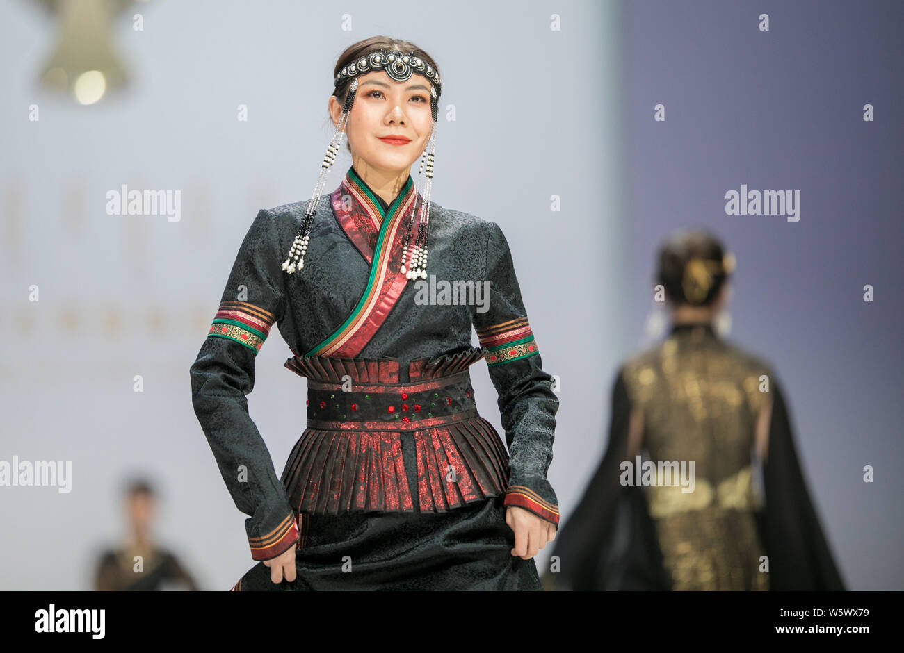 A model displays a new creation of traditional Mongolian costumes ...