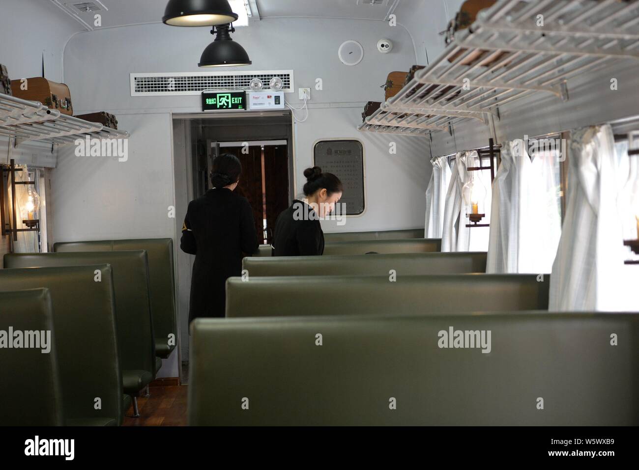 Waitresses dressed as train attendants serve customers at a restaurant ...
