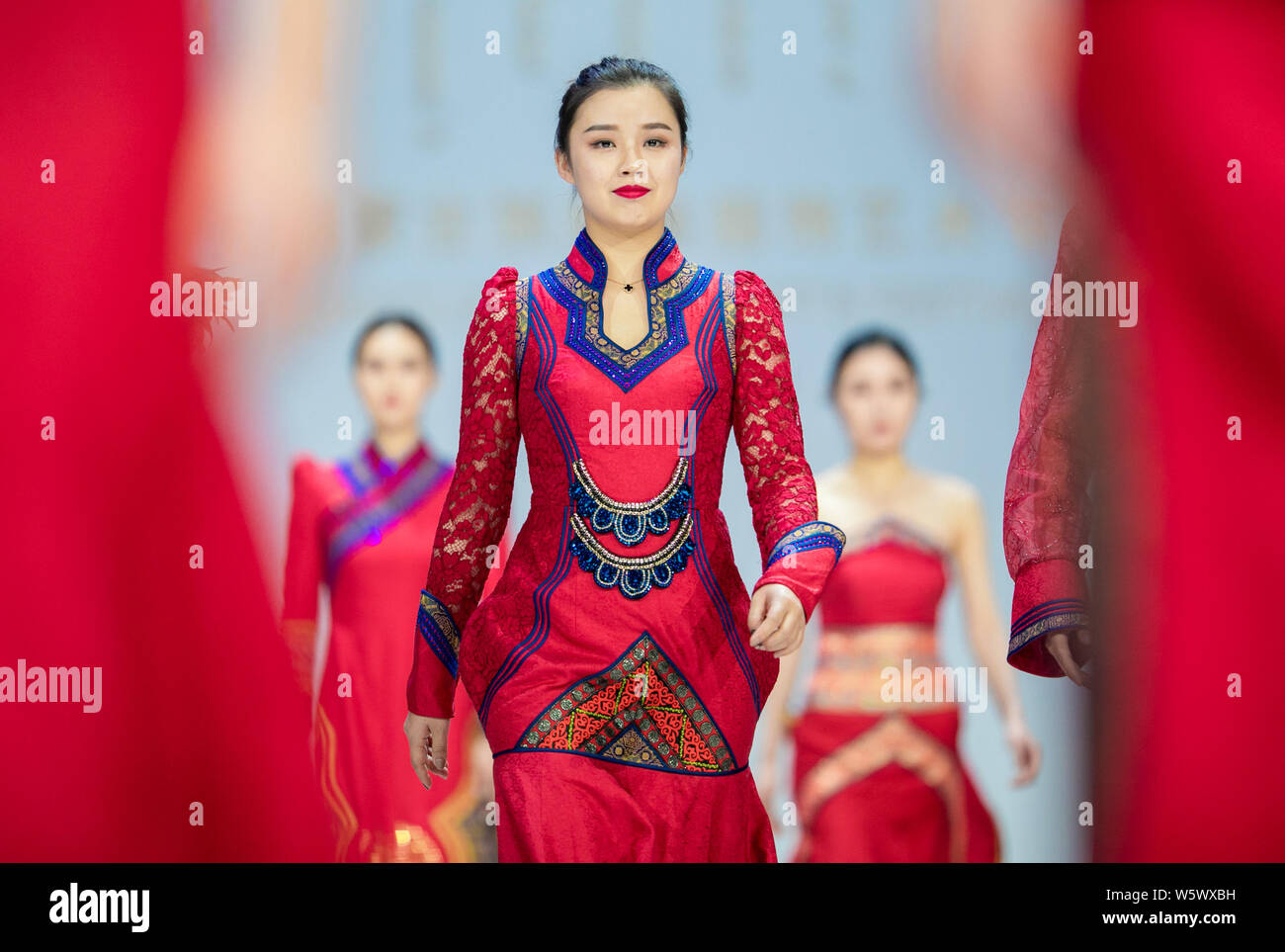 A model displays a new creation of traditional Mongolian costumes ...