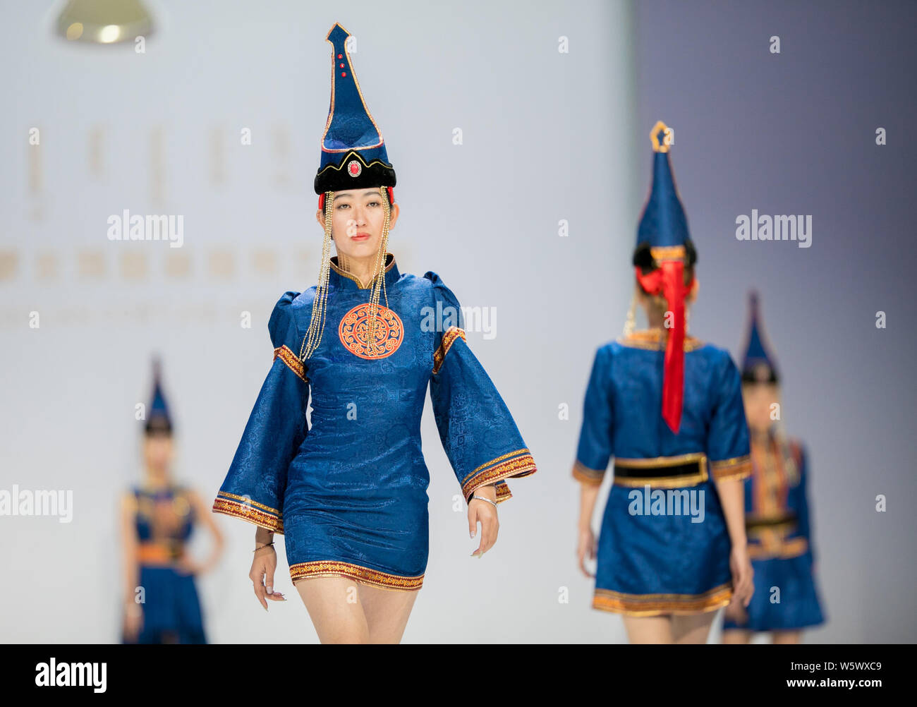 A model displays a new creation of traditional Mongolian costumes ...