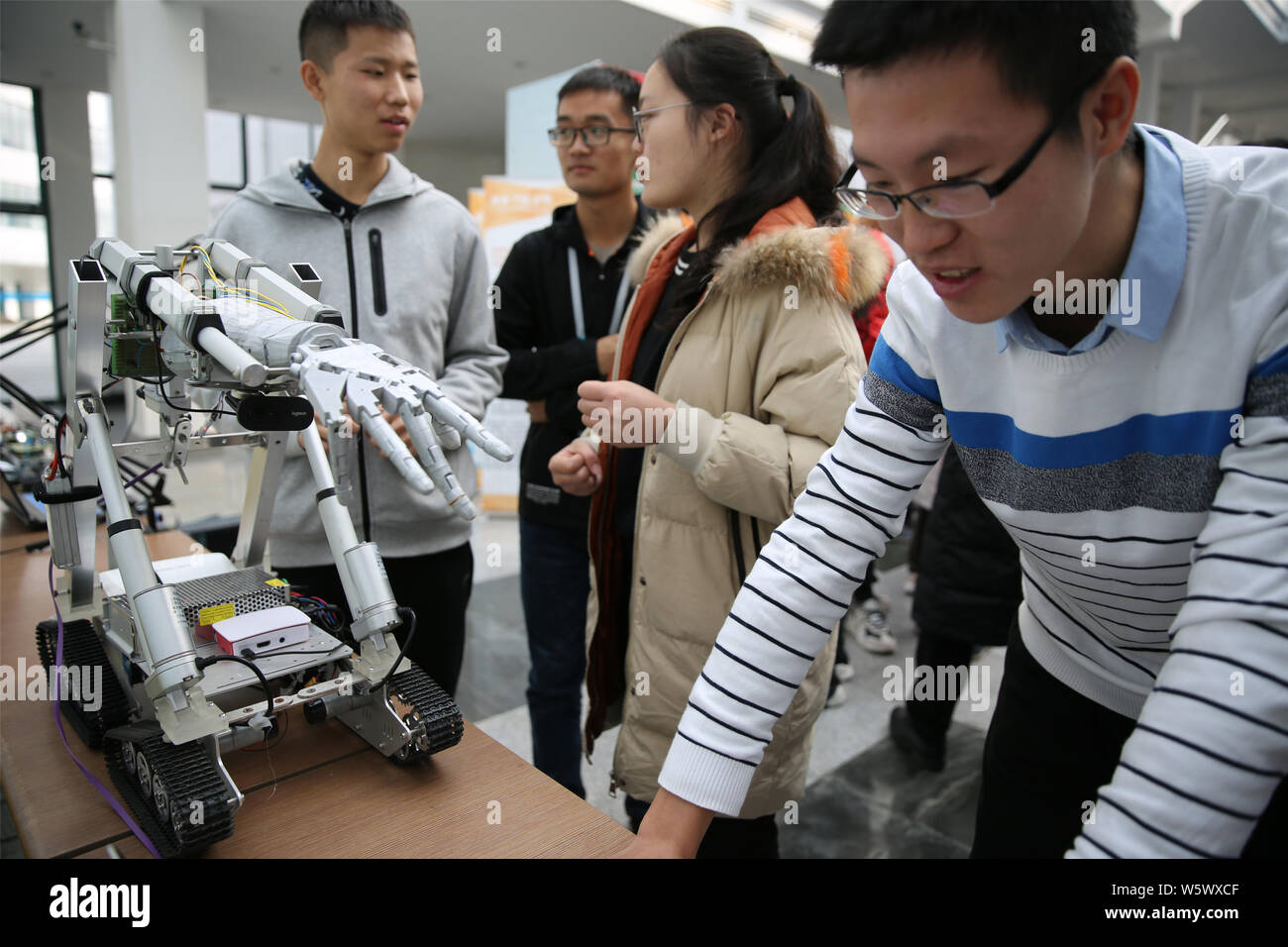 Students from a university present a bionic robotic arm during the ...