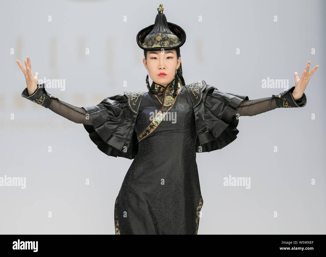 A model displays a new creation of traditional Mongolian costumes ...