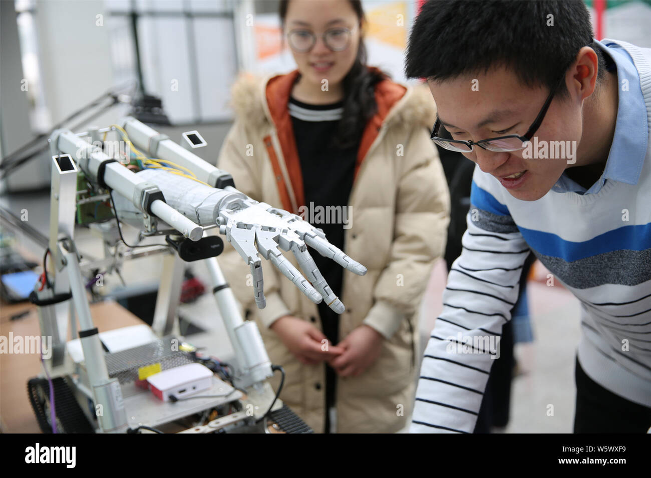 Students from a university present a bionic robotic arm during the ...