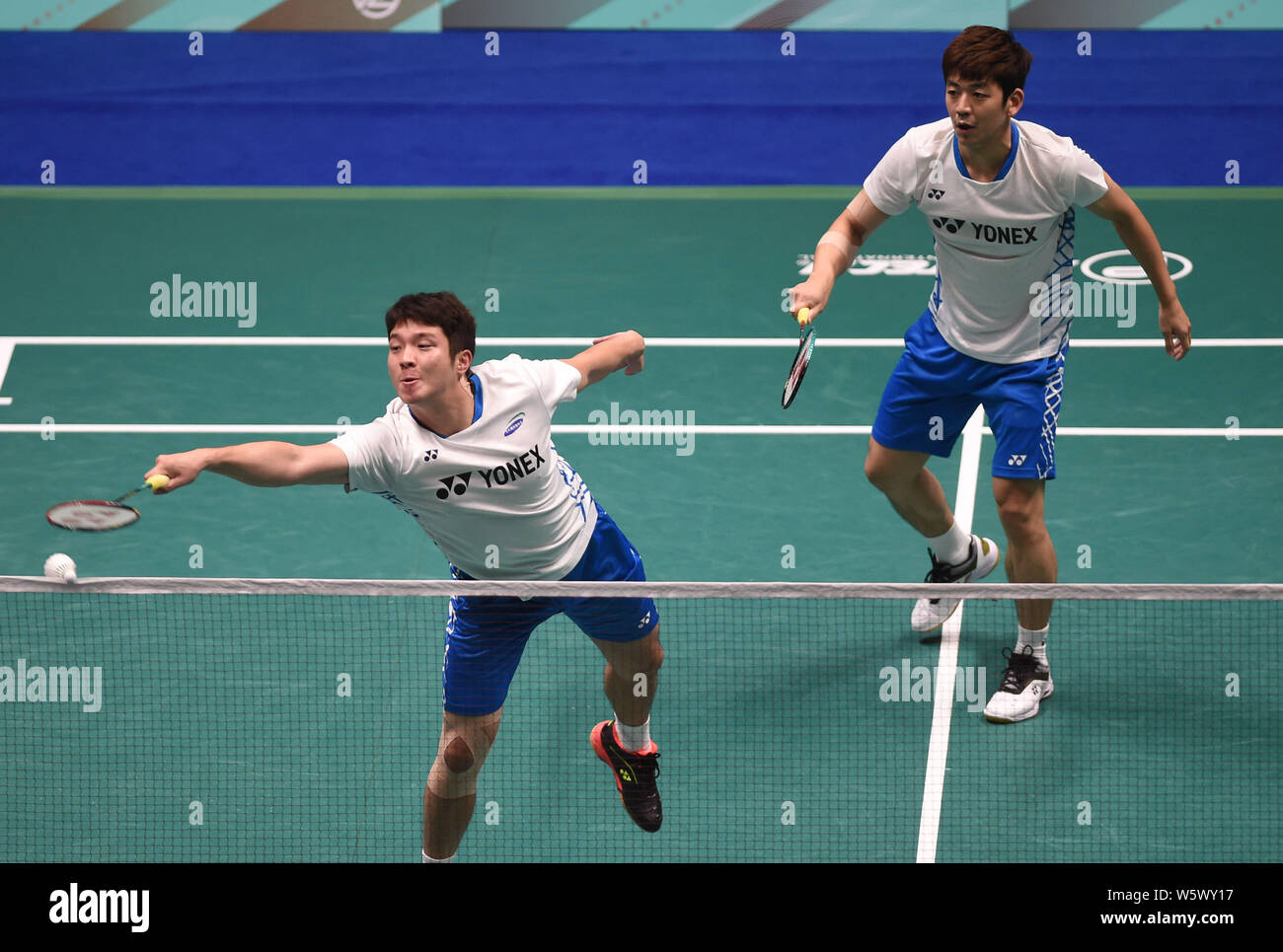 Kim Gi-jung and Lee Yong-dae of South Korea compete against Ko Sung ...