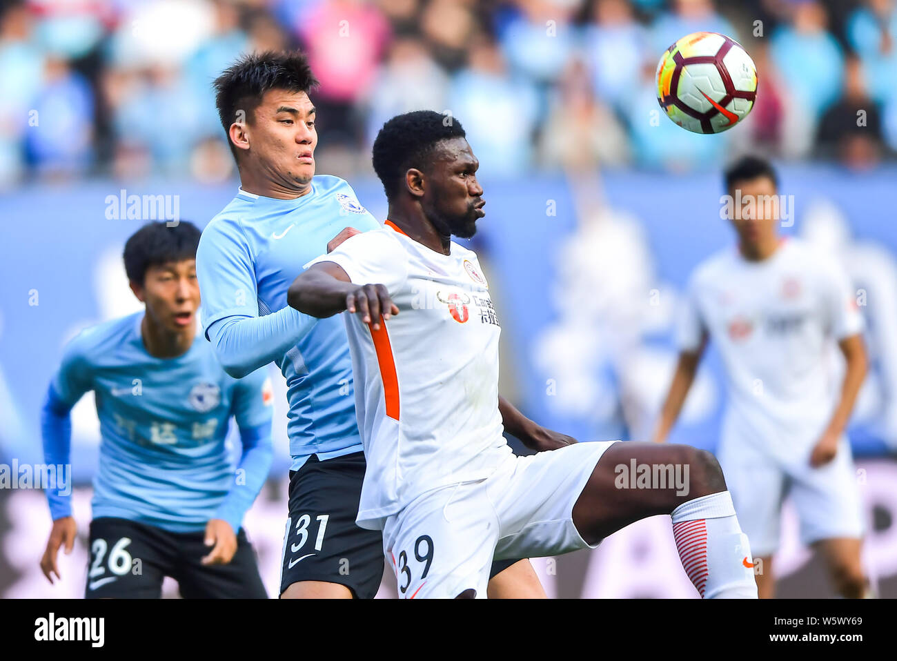 Senegalese football player Makhete Diop, right, of Beijing Renhe passes ...